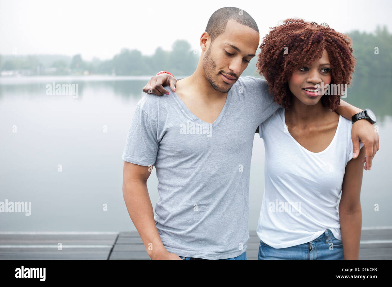 Young couple with arms around each other hi-res stock photography and ...