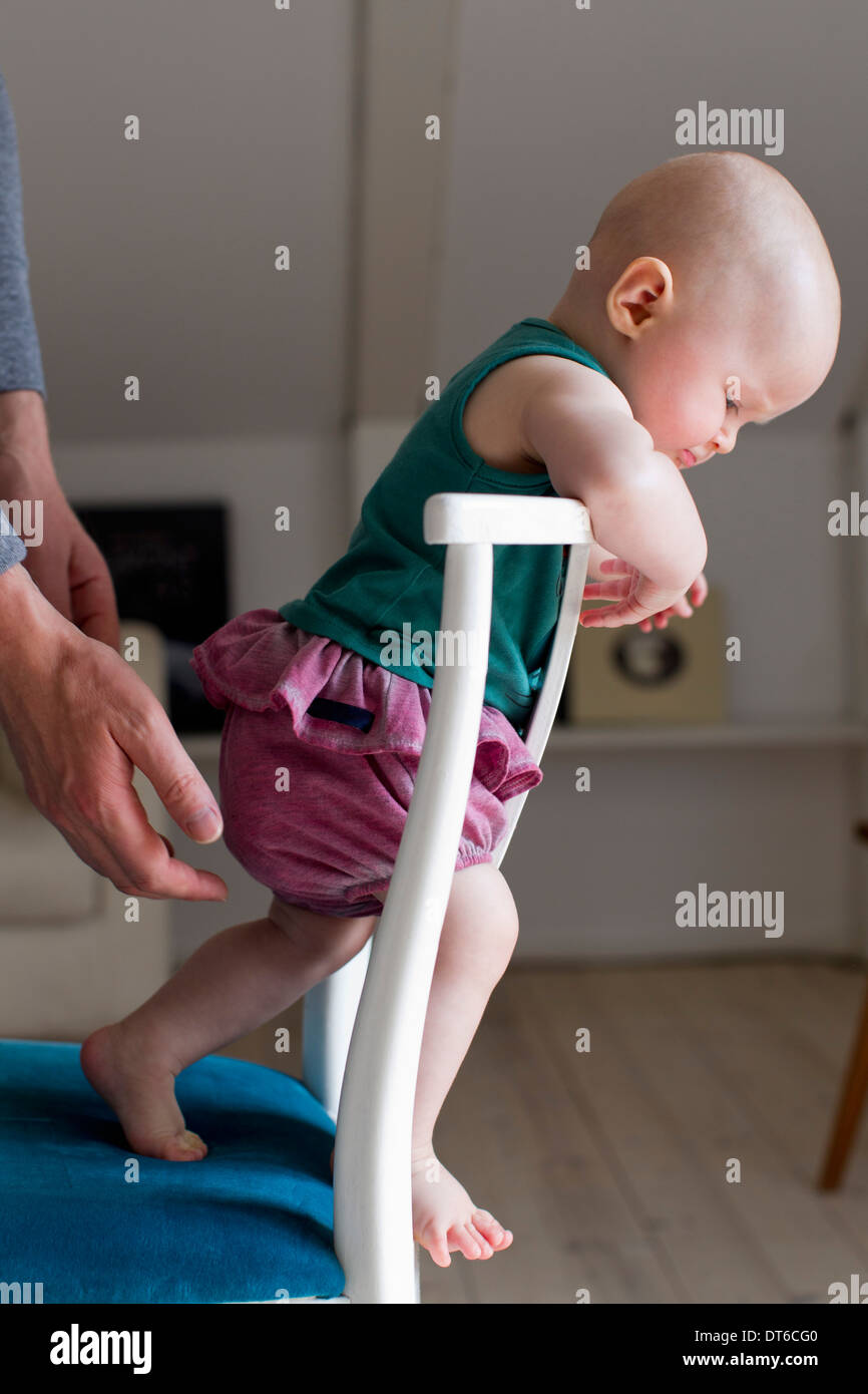 Baby girl standing hi-res stock photography and images - Alamy