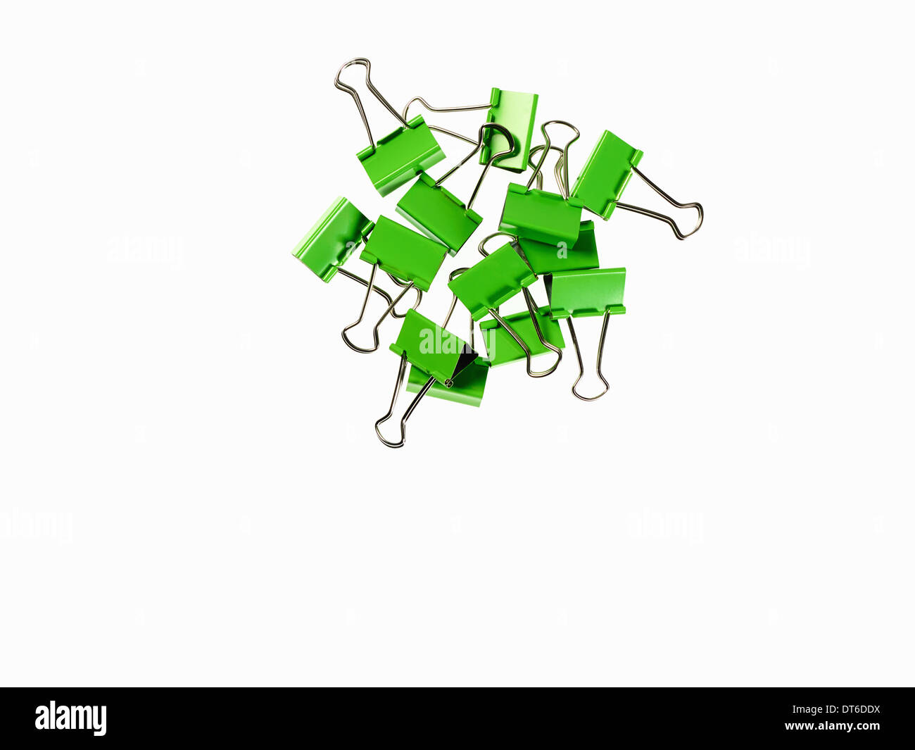 Green Office Supplies. Paperclips on a white background Stock Photo - Alamy