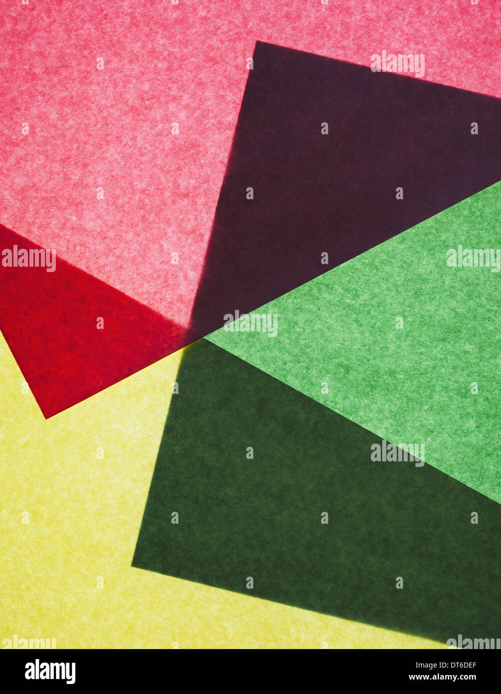 Pieces of colourful, recycled construction paper, overlapping and laid ...