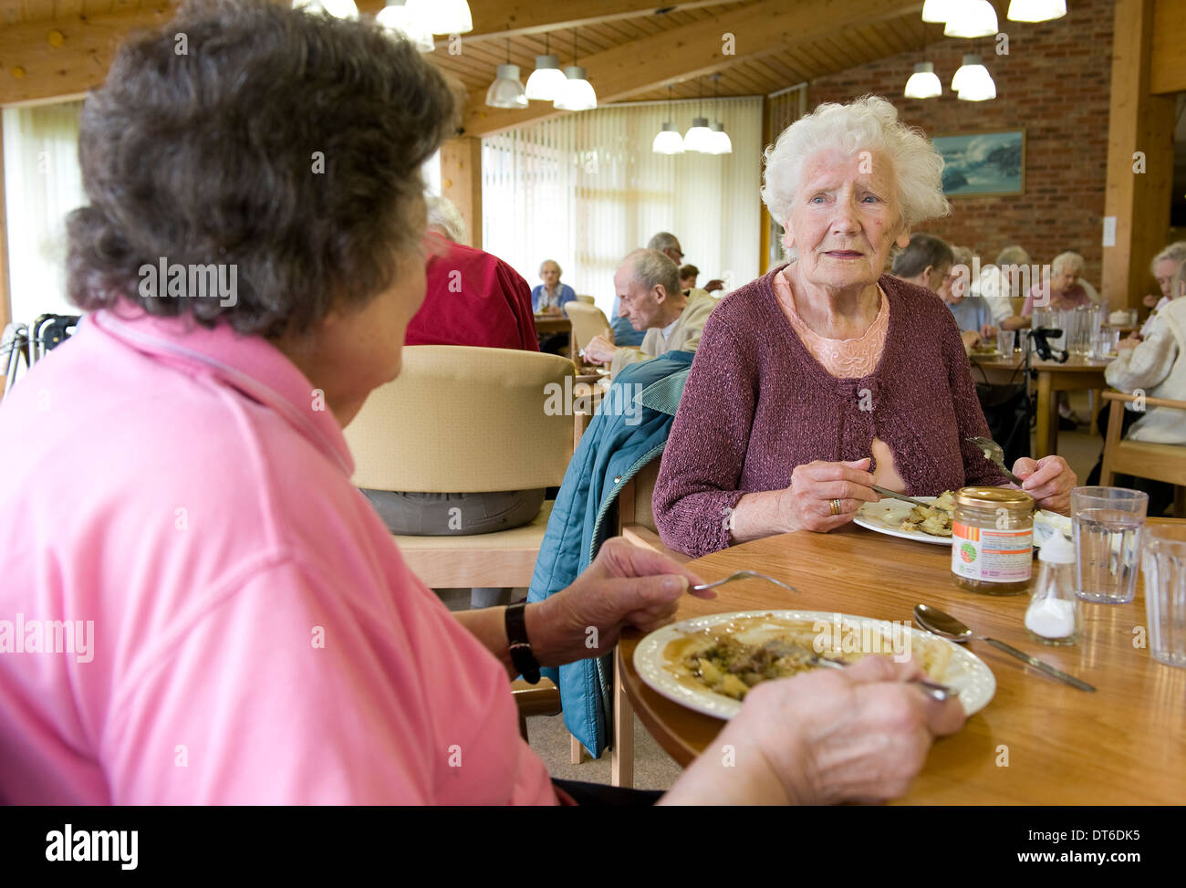 An elderly person / pensioner enjoying her lunch at an old peoples ...
