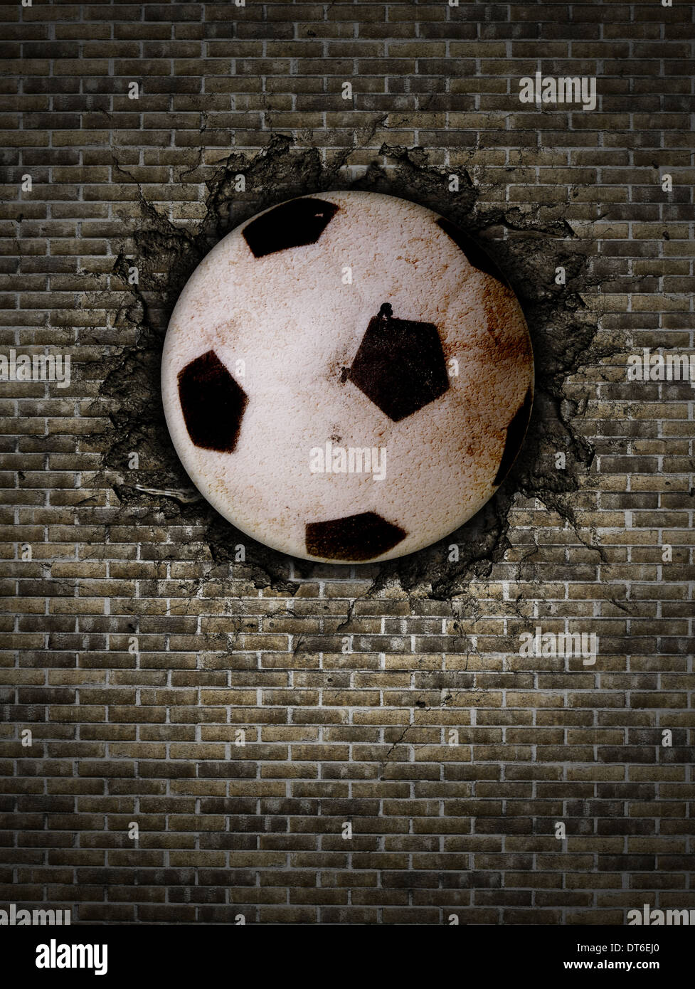 a soccer ball destroy a brick wall Stock Photo - Alamy