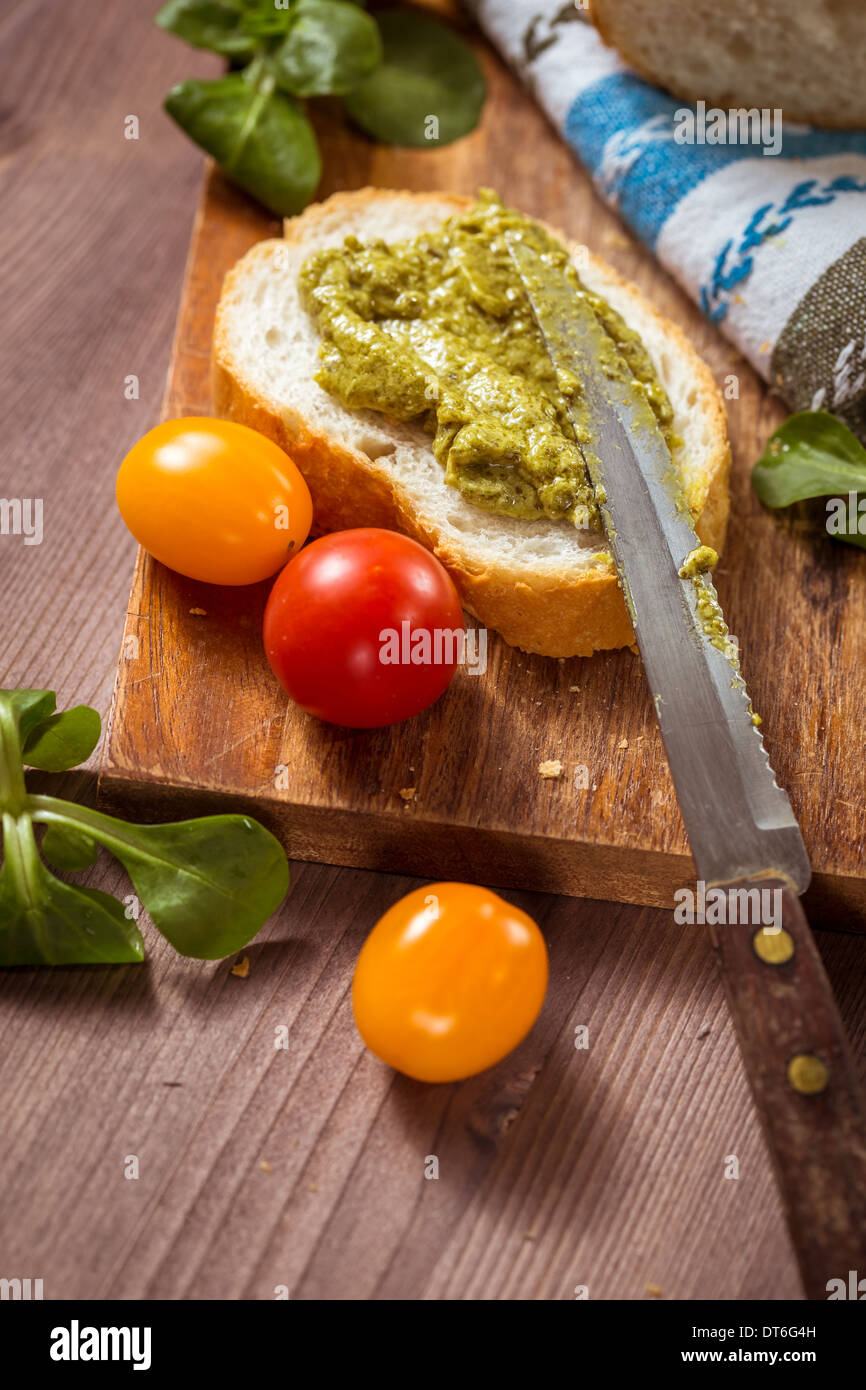 baguette as a snack with fresh pesto and tomatos Stock Photo - Alamy