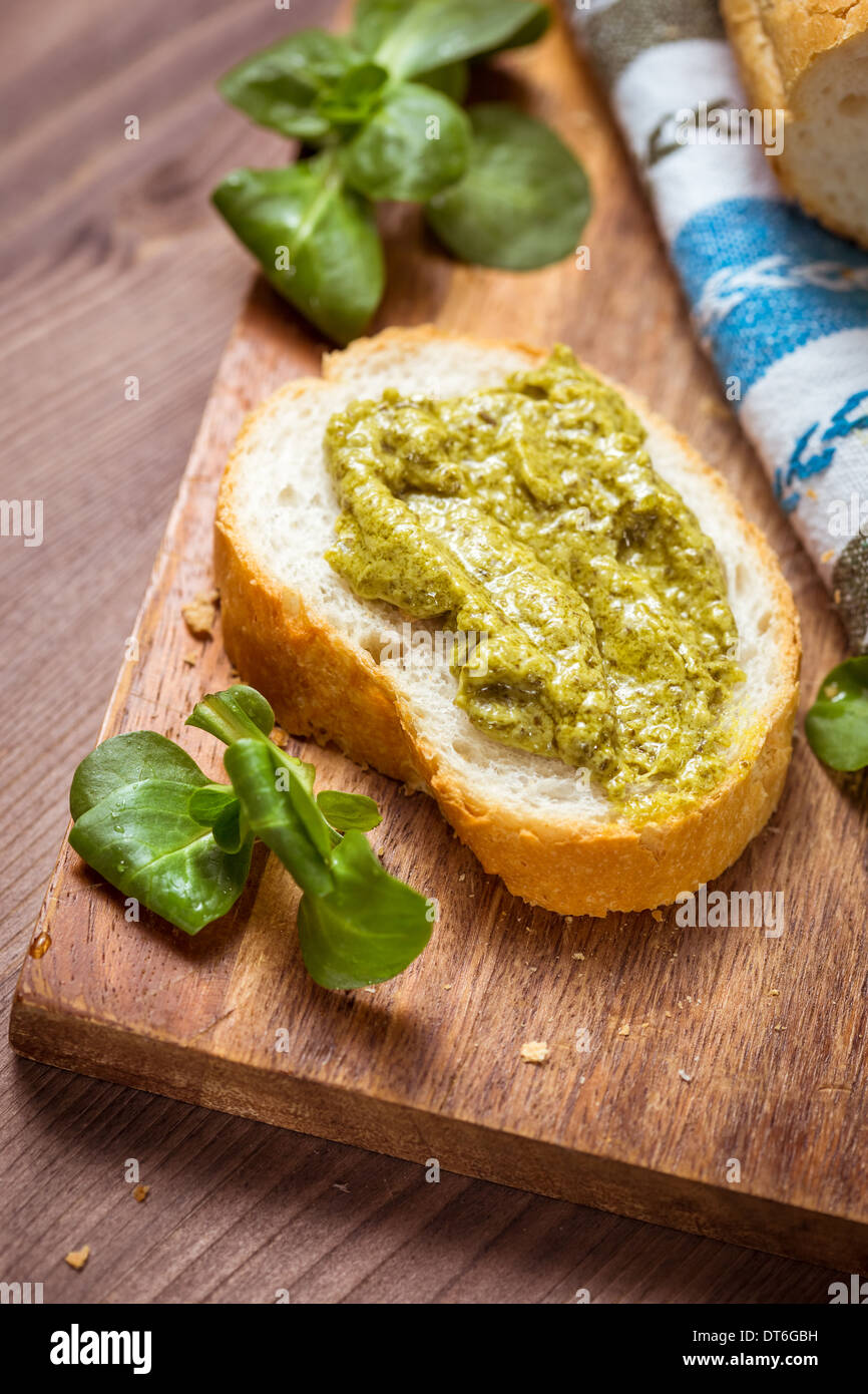 Baguette as a snack with fresh pesto and tomatos Stock Photo - Alamy