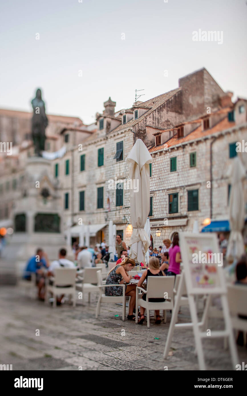 Square with restaurants and terraces in the evening Stock Photo - Alamy
