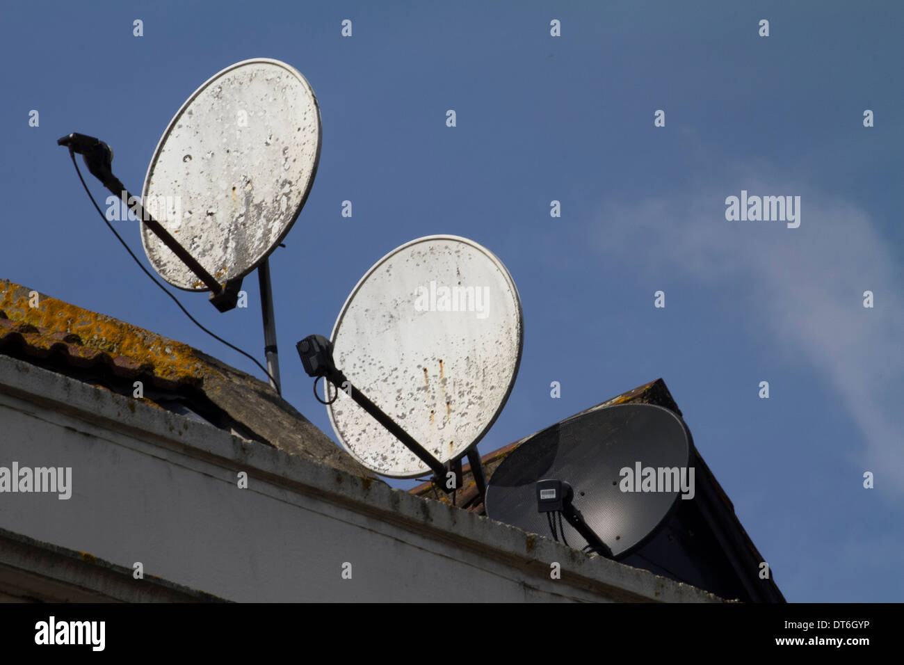 Three Satellite Television Dishes fitted on a rooftop building Stock ...