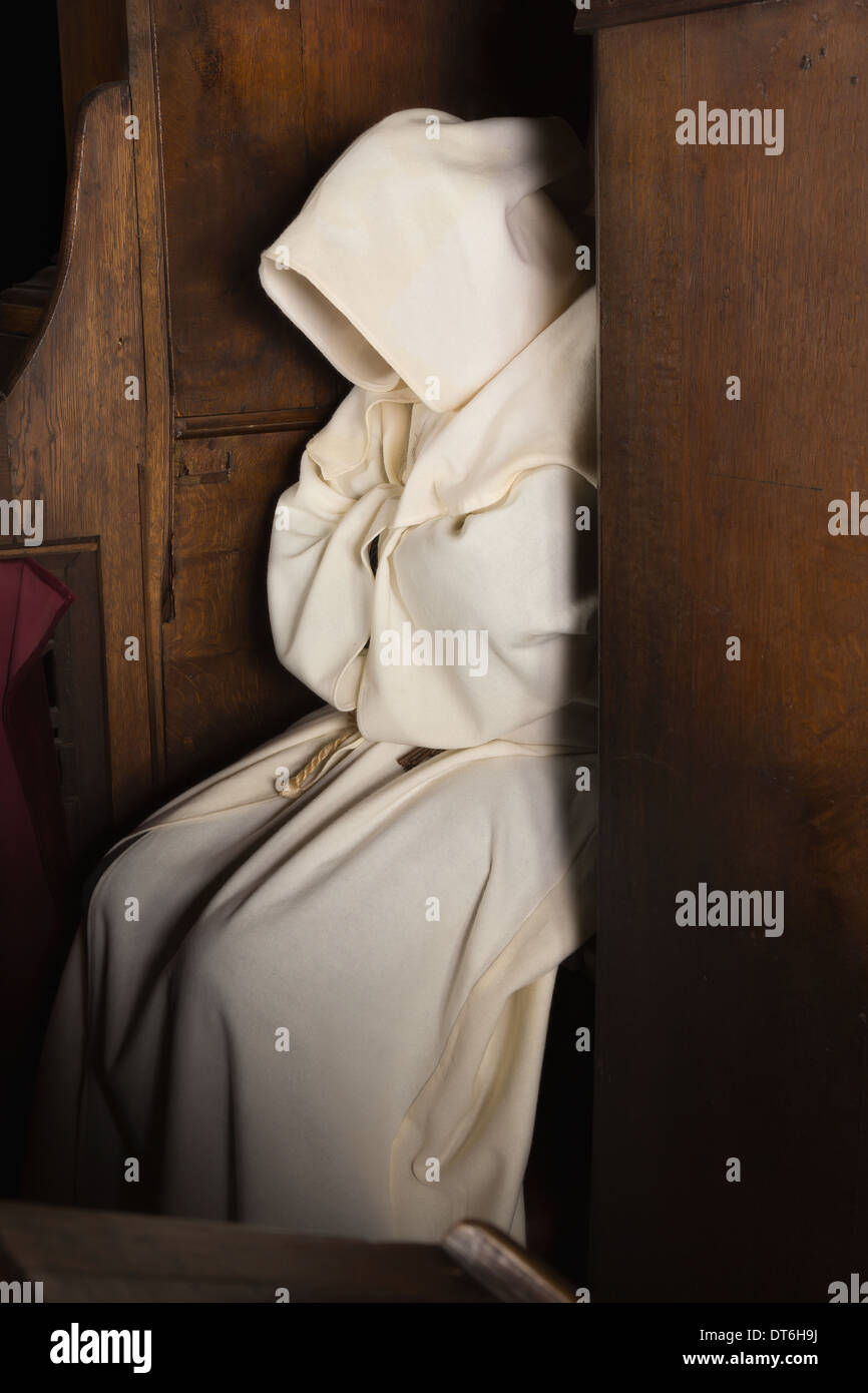 Monk with hood sitting in a wooden corner of a medieval church Stock ...