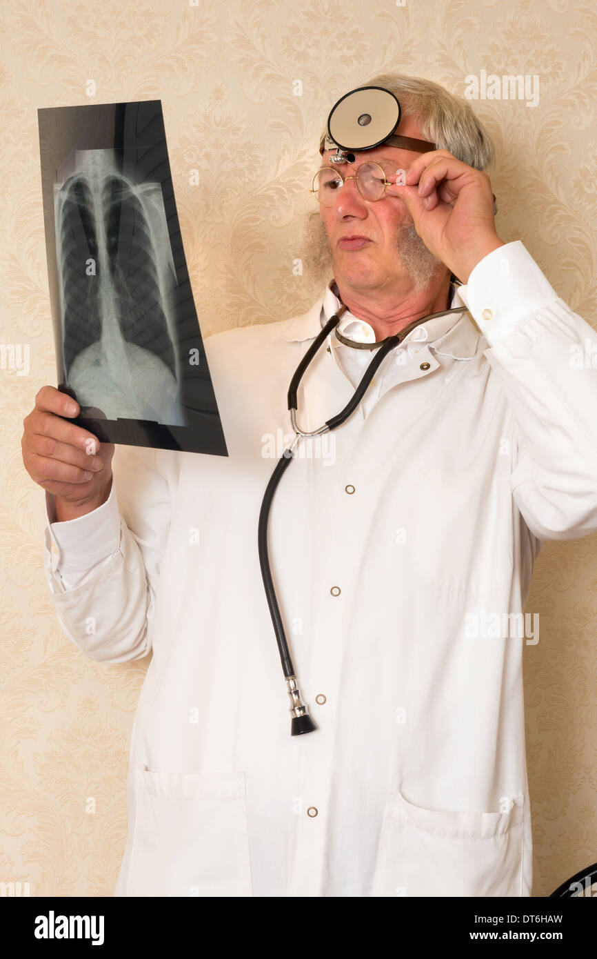 Vintage doctor examining an x-ray in his clinic Stock Photo - Alamy