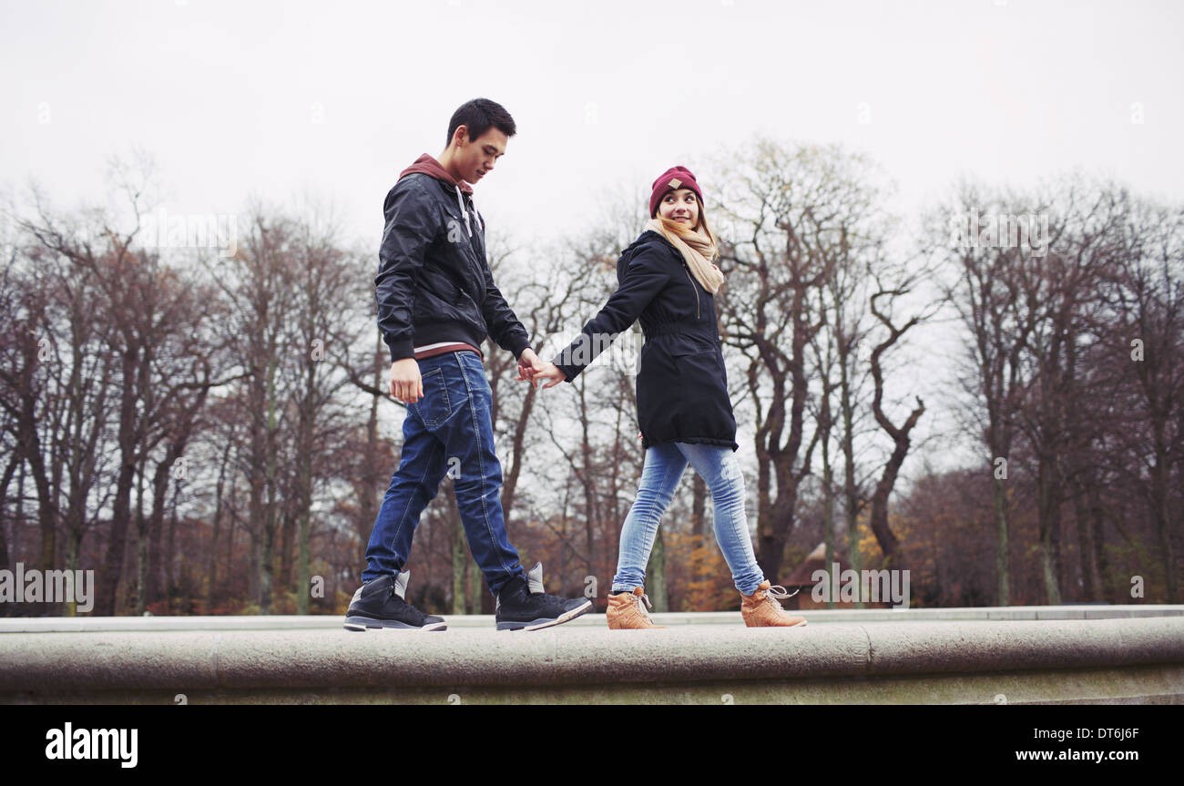 Low angle view of handsome young man with his girlfriend walking ... Low angle view of handsome young man with his girlfriend walking ...