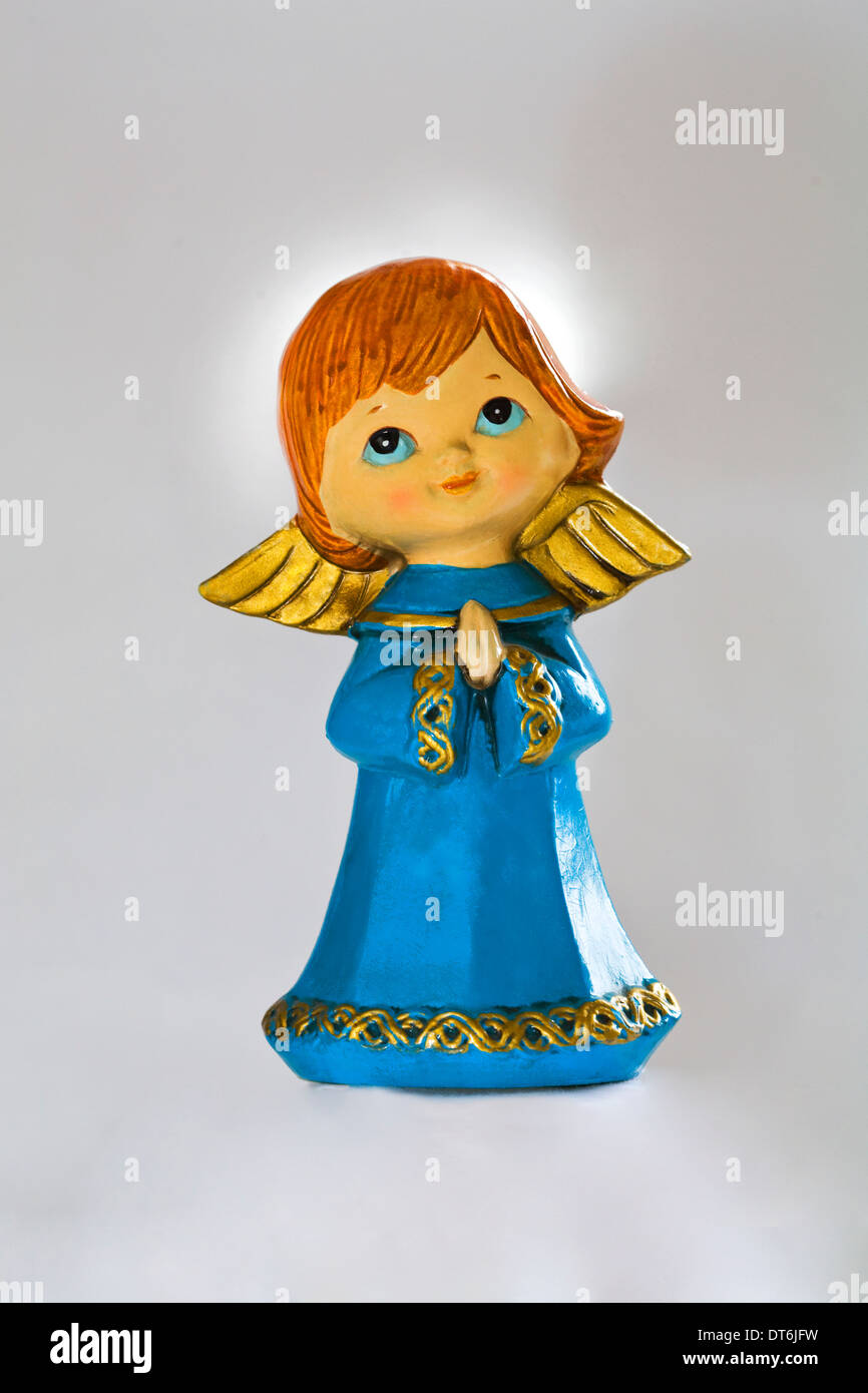 A pretty little angel with big eyes and gold wings on a cloud Stock ...