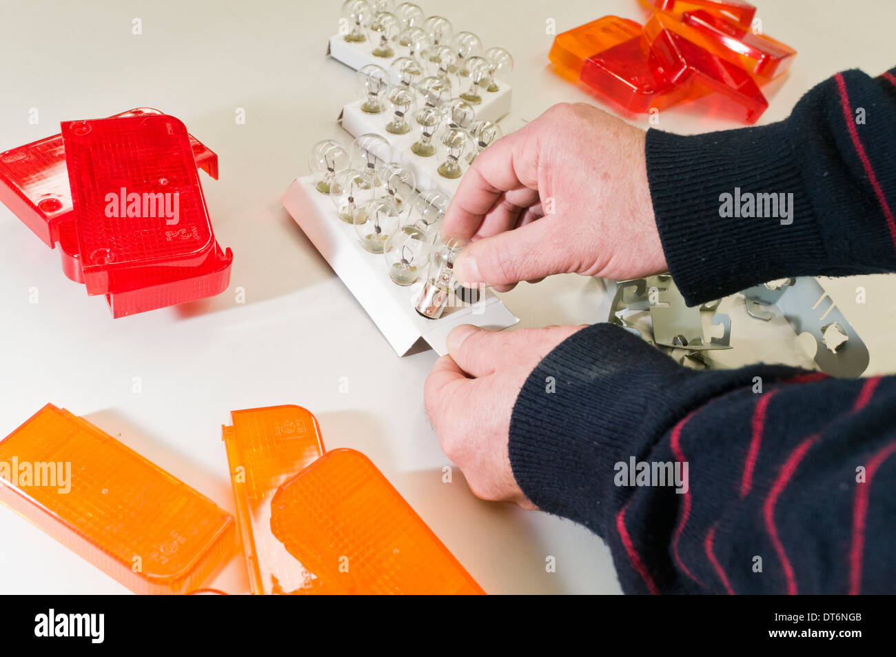 Man assembling automotive lights in a factory production line Stock ...