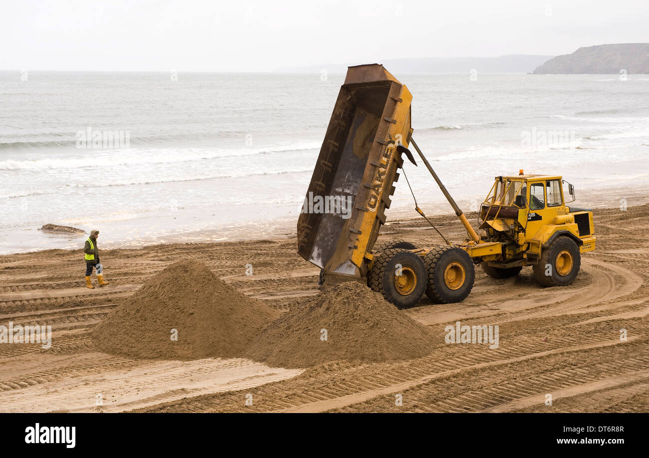 Sand is moved by dumper trucks on the beach at Scarborough, North ...