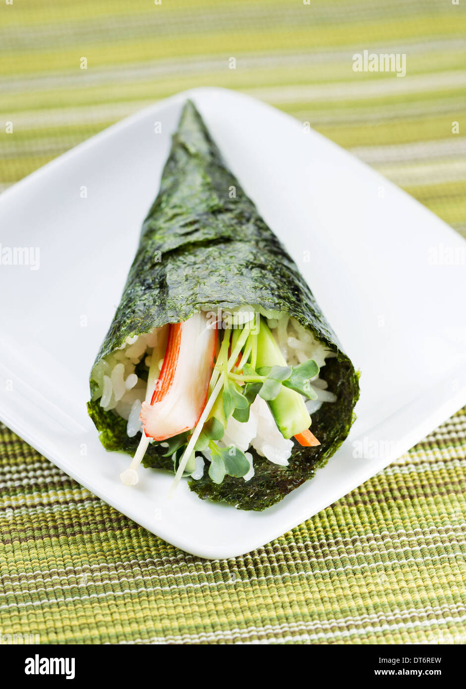 Closeup vertical photo of freshly handmade Temaki sushi cone in white ...
