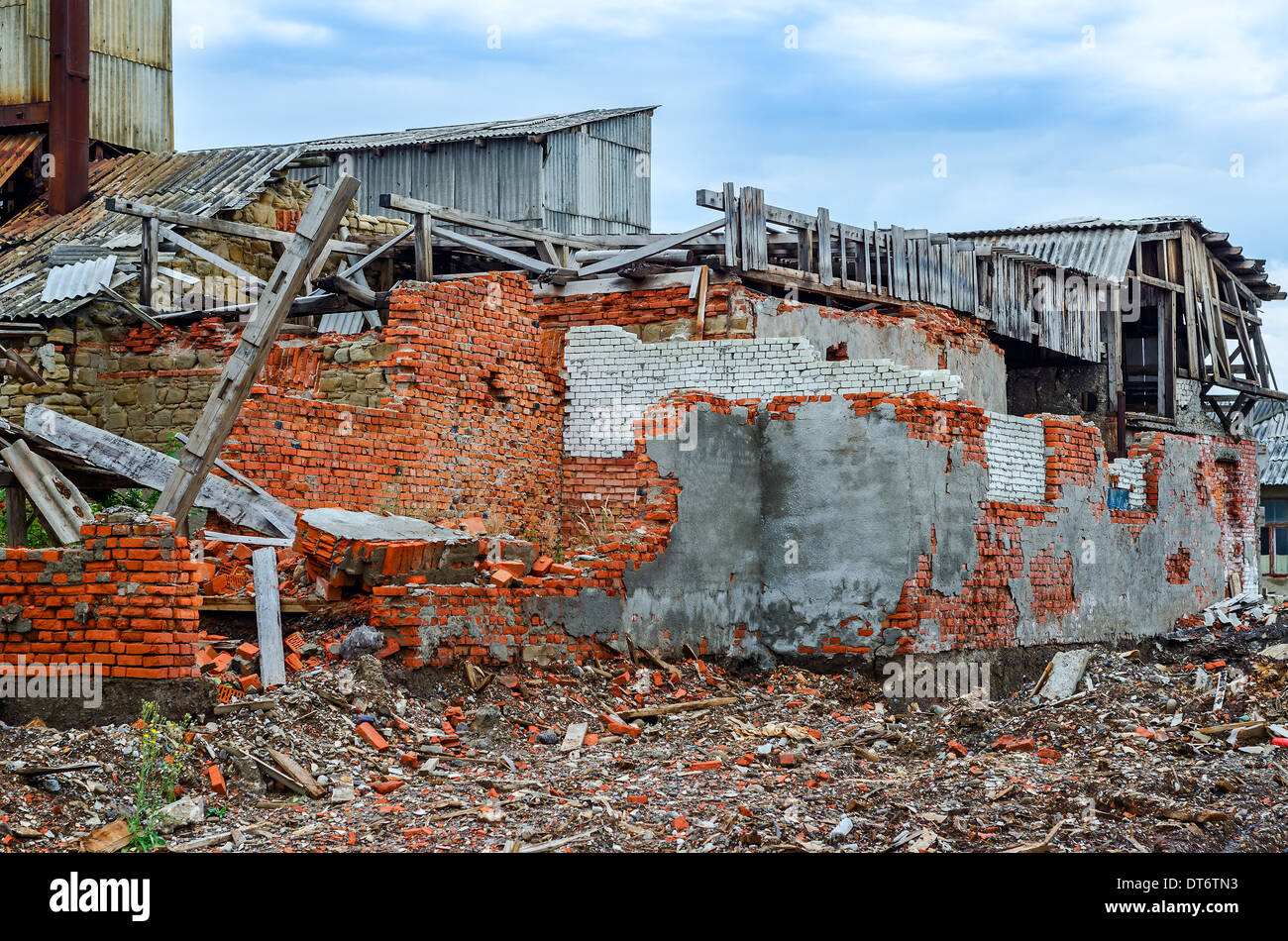 Destroyed industrial building constructed of red bricks on crisis time ...