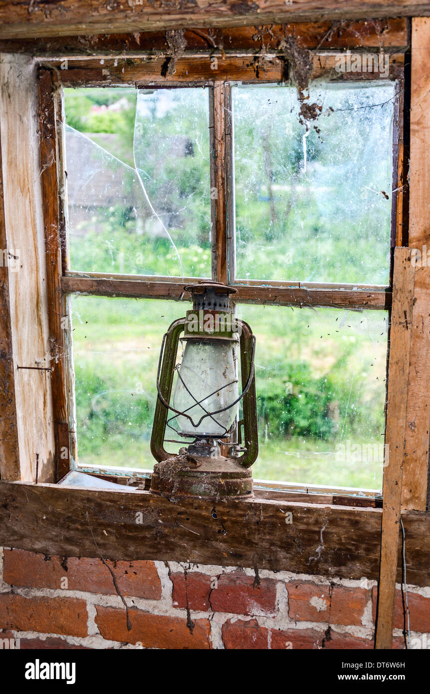 Oil Lamp on old broken window sill Stock Photo - Alamy