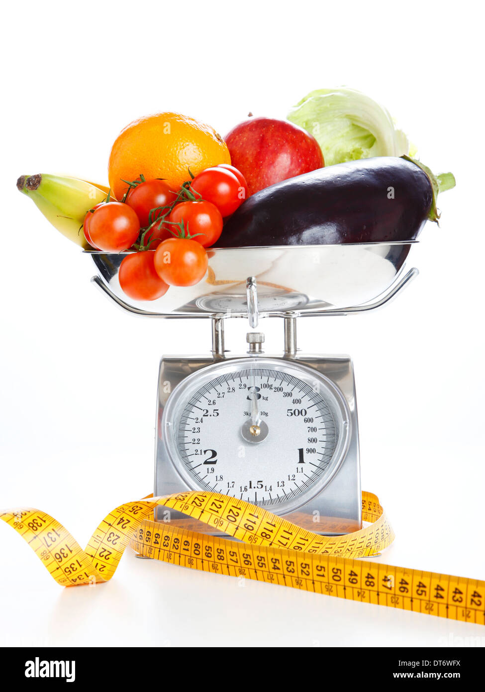 Fruits and vegetables on a balance isolated on a white background Stock ...
