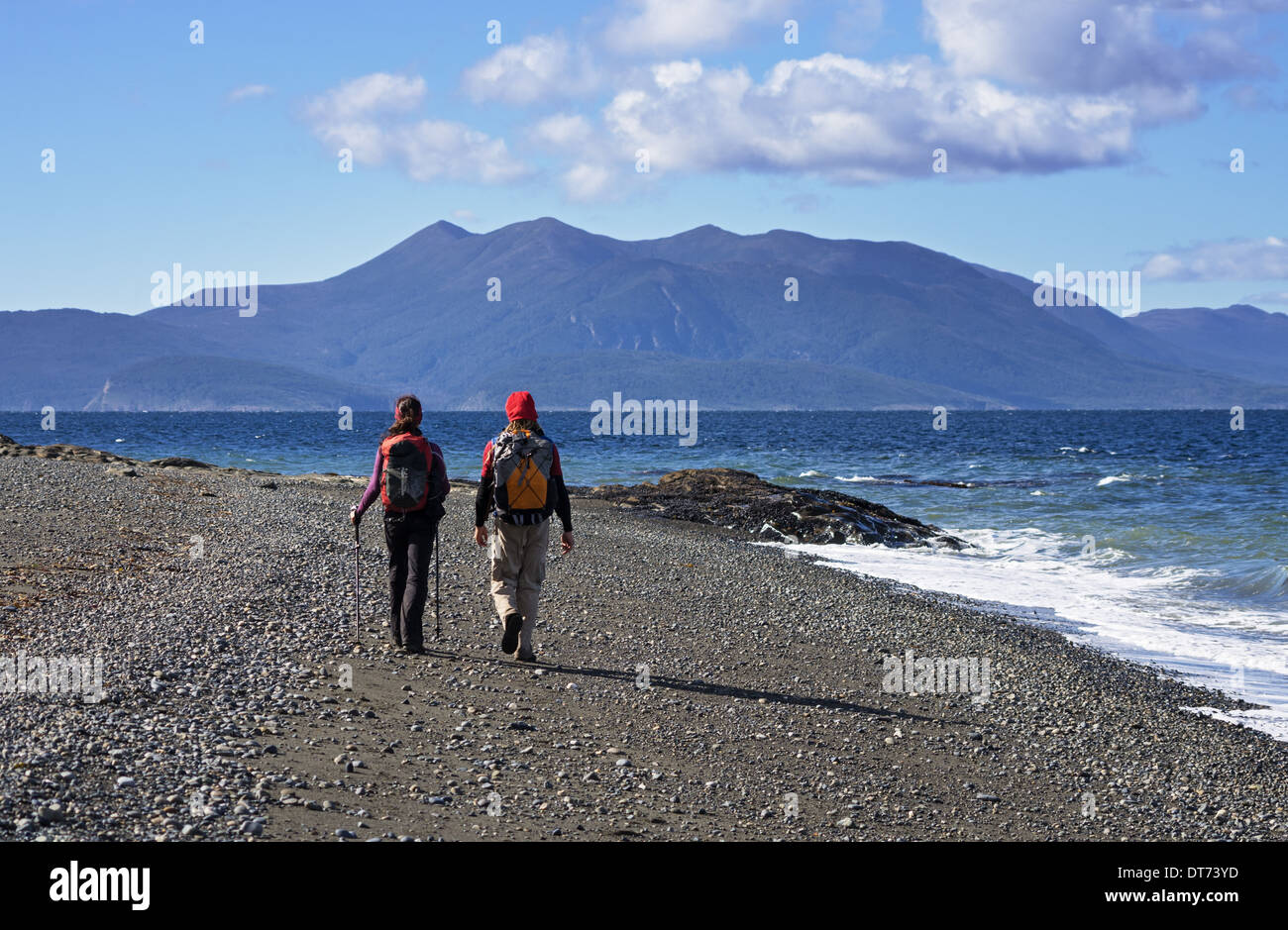 couple trekking on a beach in Patagonia along the straits of Magellan ...