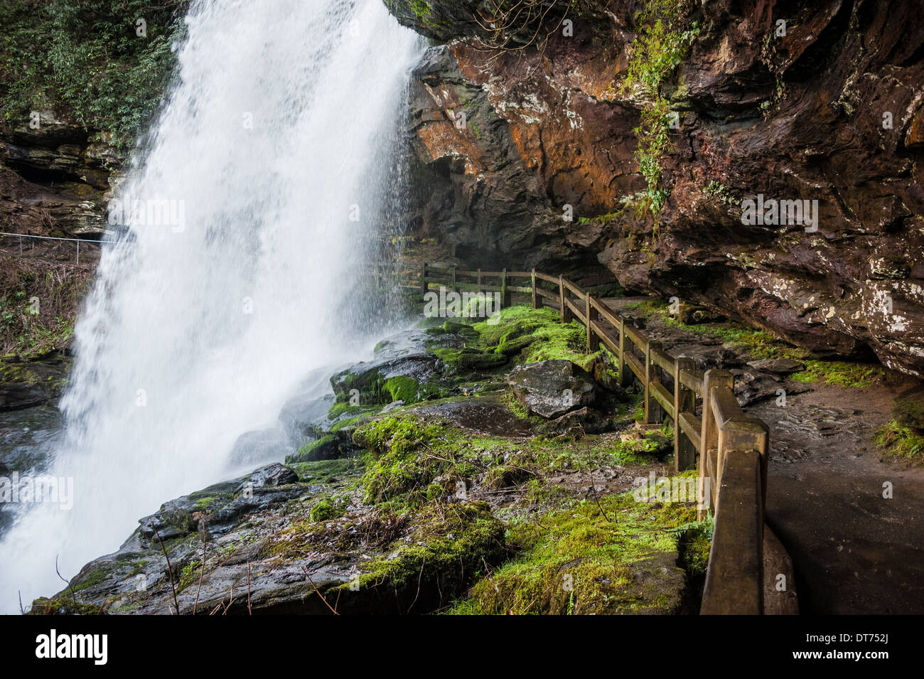 A walking path winds behind a roaring waterfall called Dry Falls in the ...