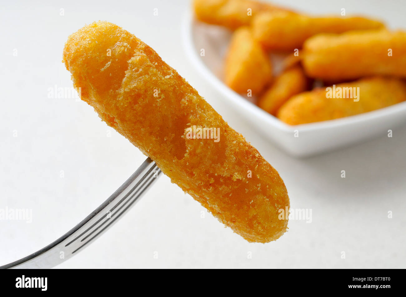 a bowl with some fish sticks served as appetizer on a set table Stock ...