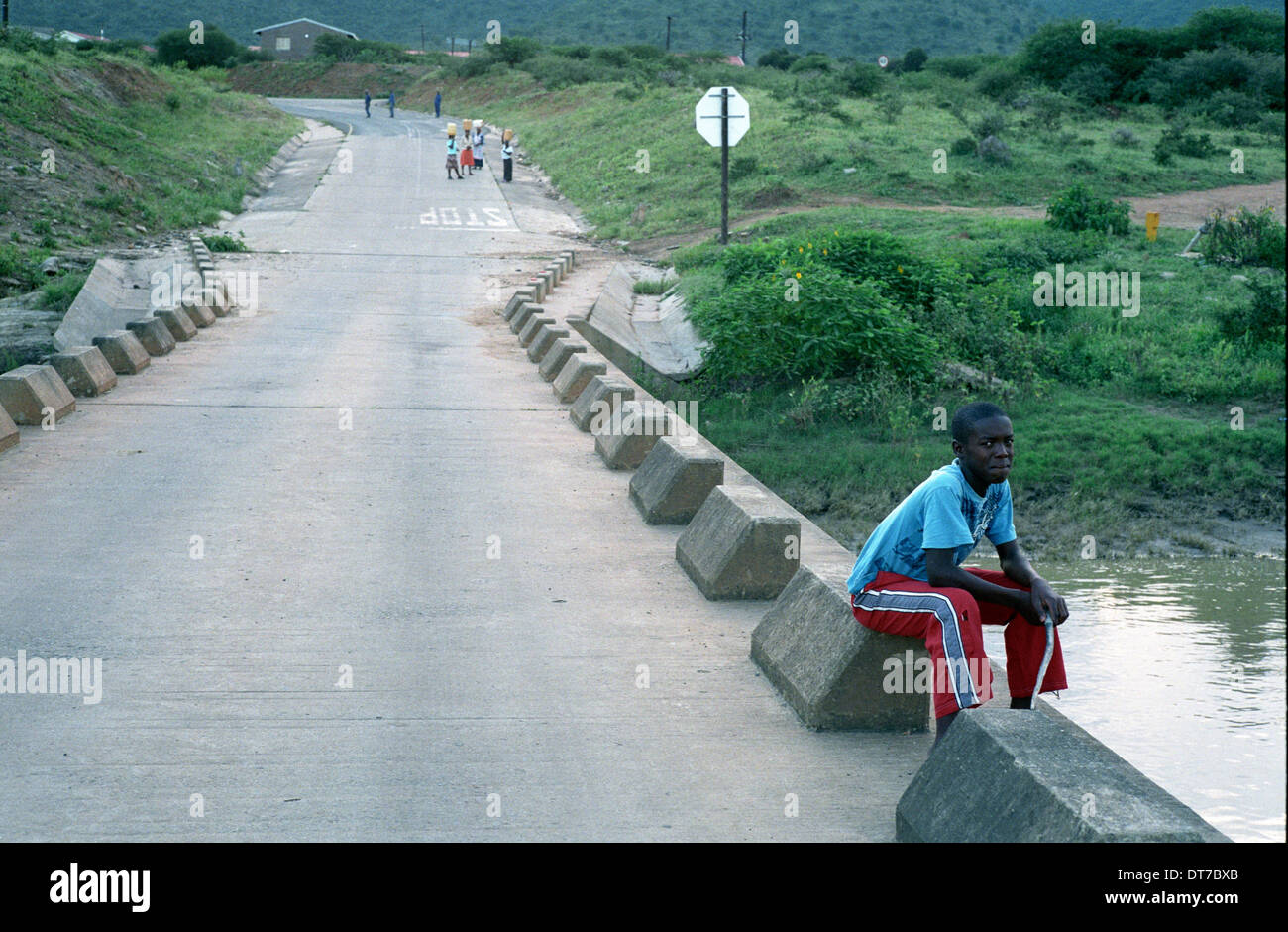 a single lane low level bridge crosses the tugela river where woman ...