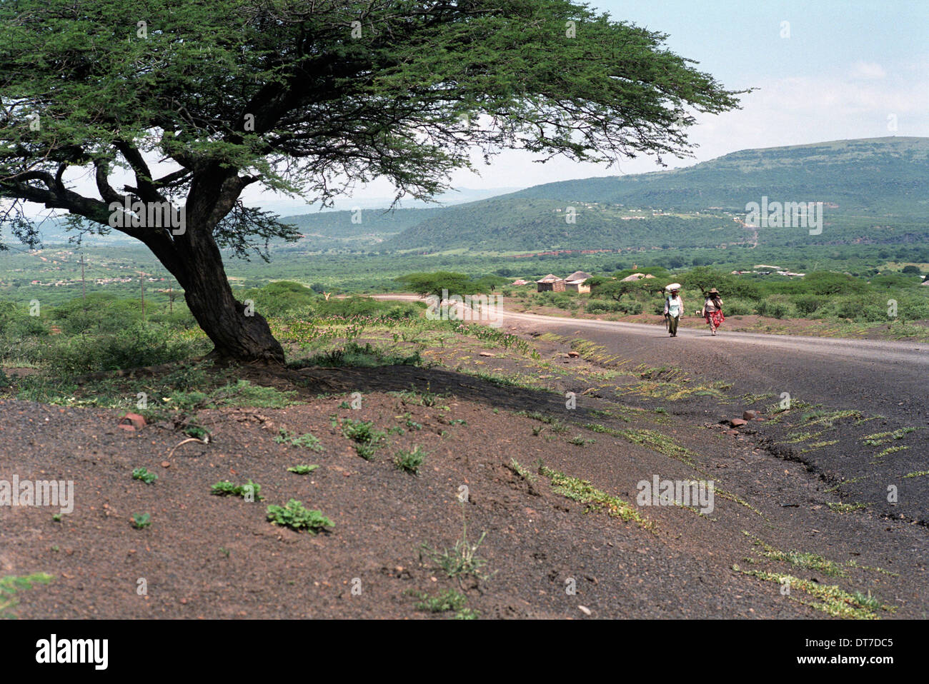 two woman walk along an unpaved road in the ulundi region of kwazulu ...
