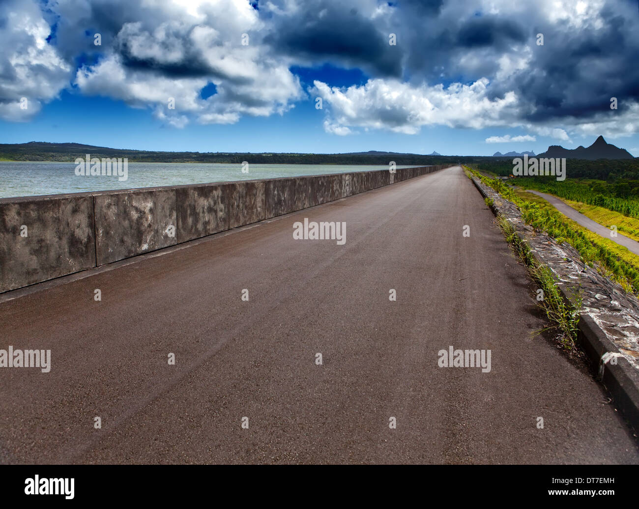 The road on an embankment at a reservoir of fresh water. Mauritius ...