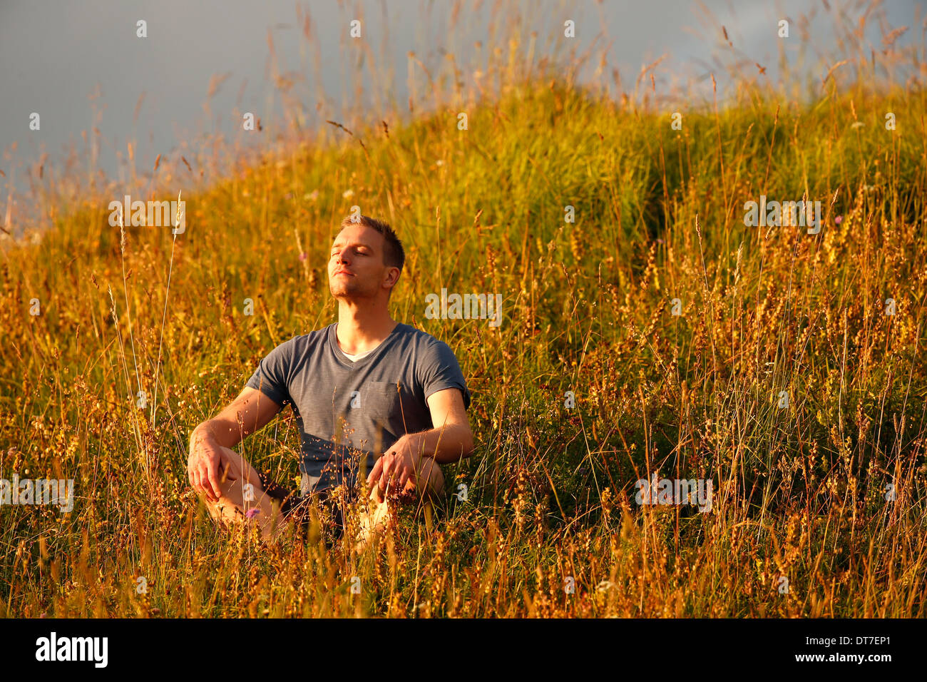 Man praying outside Stock Photo - Alamy