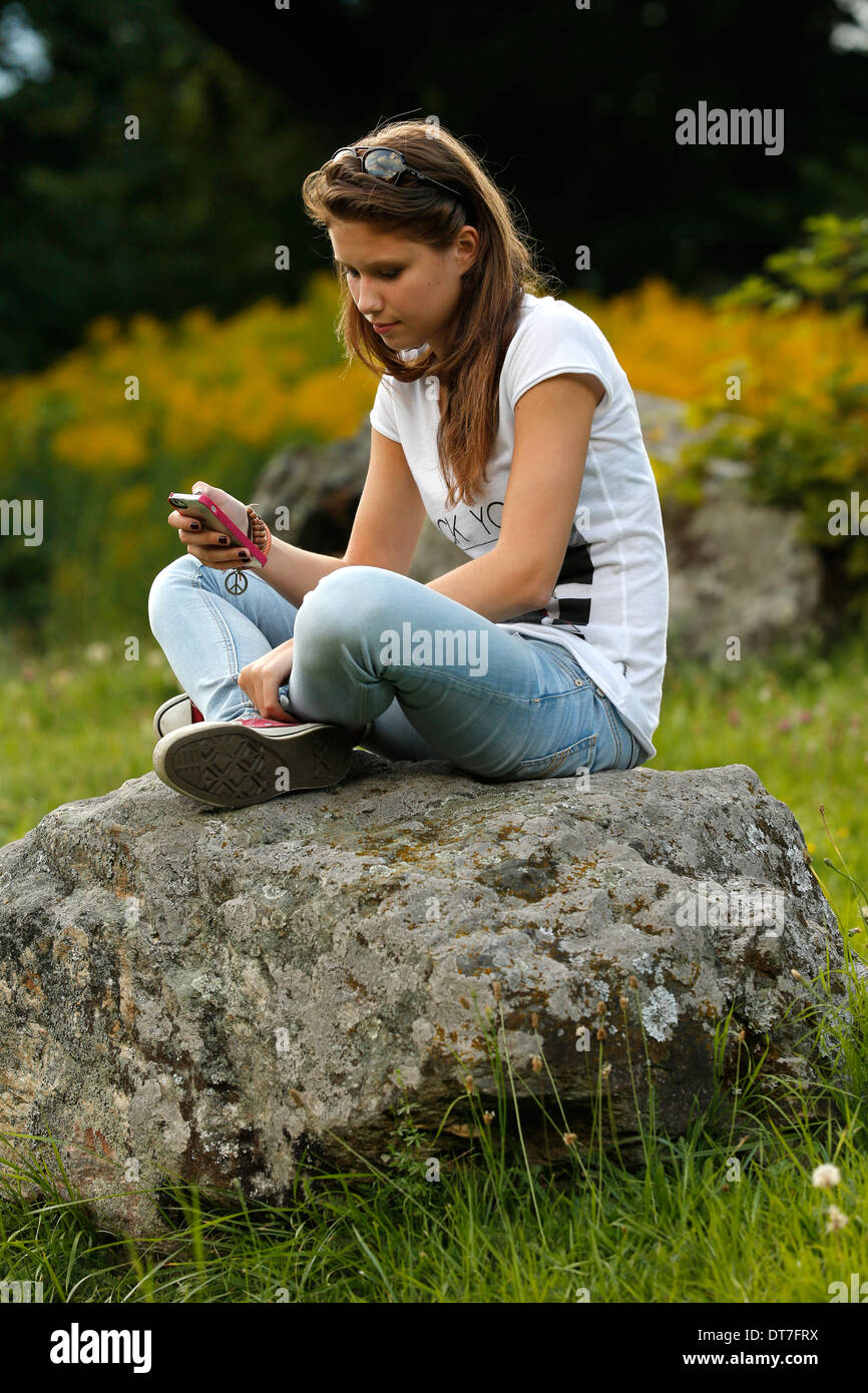 Girl using an Iphone Stock Photo - Alamy