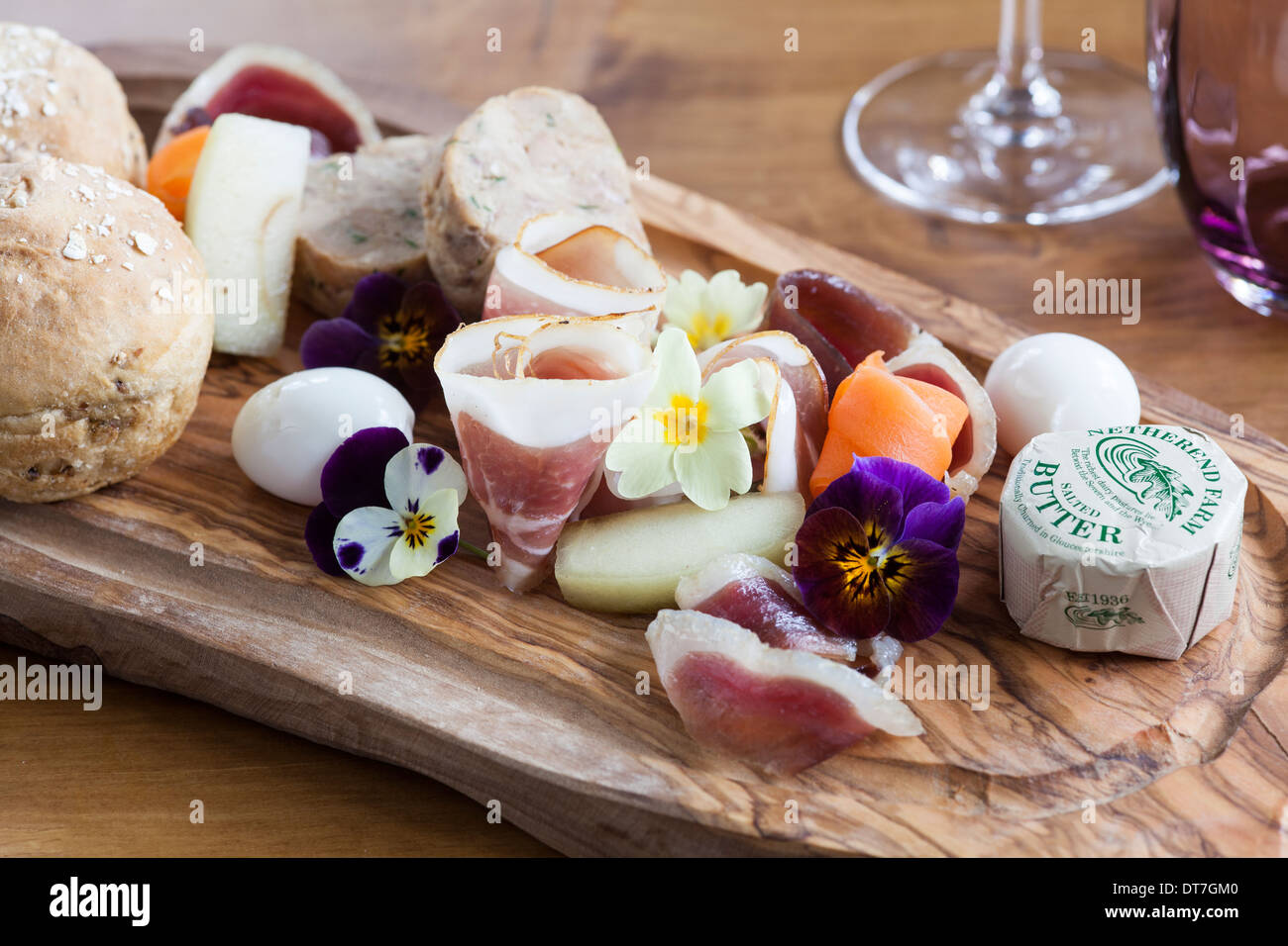 Meat platter decorated with flowers Stock Photo - Alamy