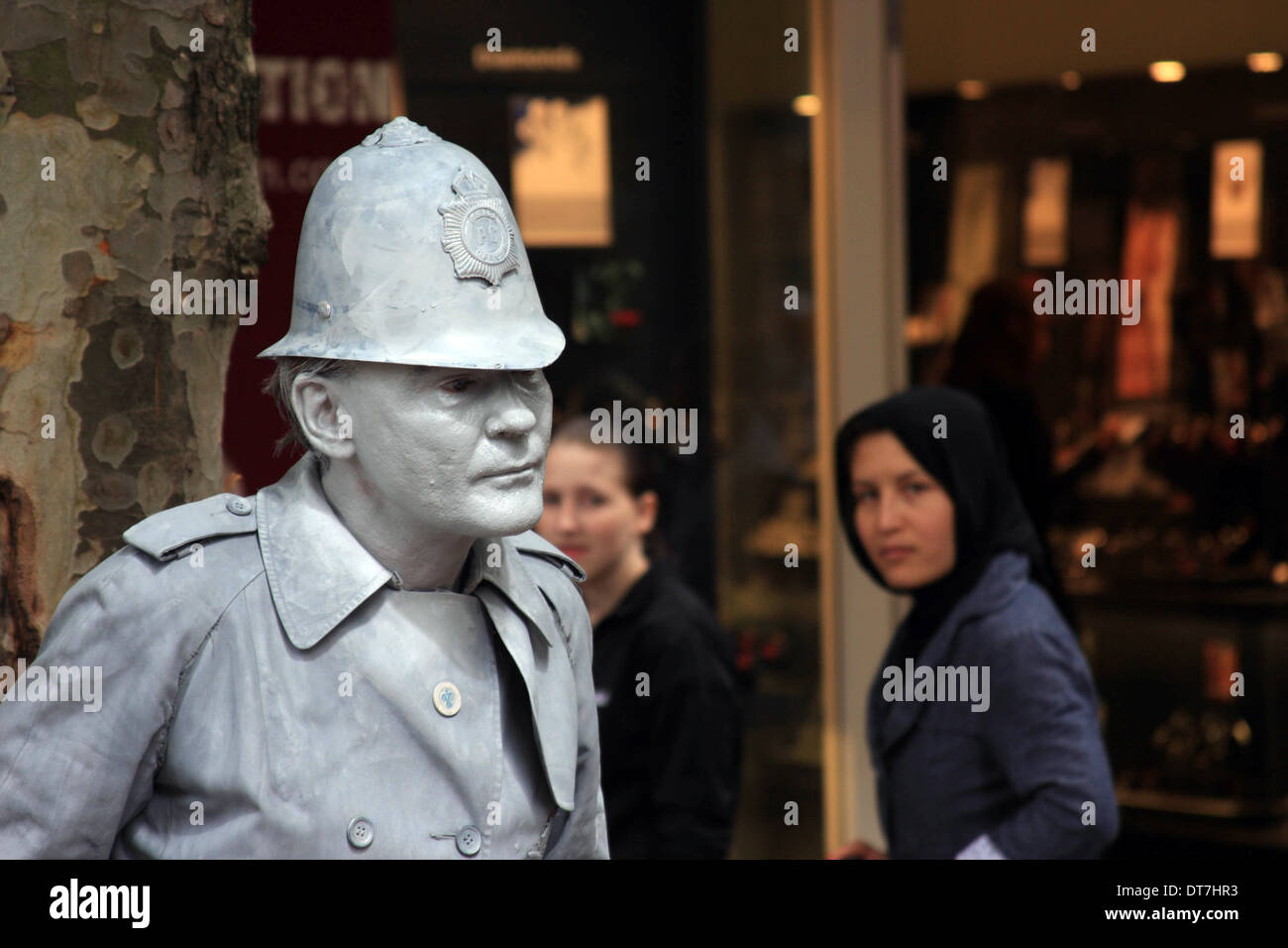 Street performer dressed as a policeman statue Stock Photo - Alamy
