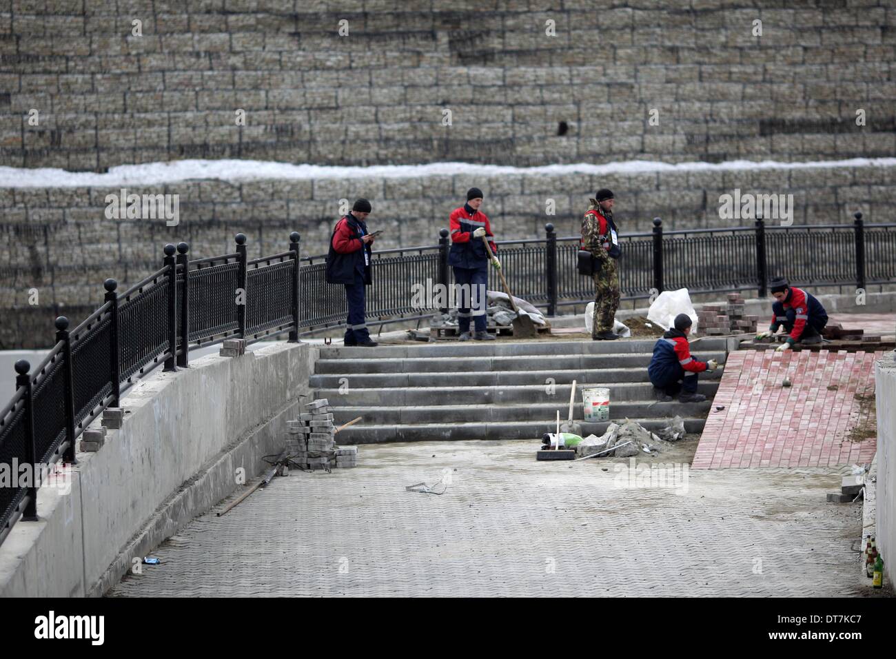 Krasnaja Poljana, Russia. 11th Feb, 2014. Employees work on a walkway ... Krasnaja Poljana, Russia. 11th Feb, 2014. Employees work on a walkway ...