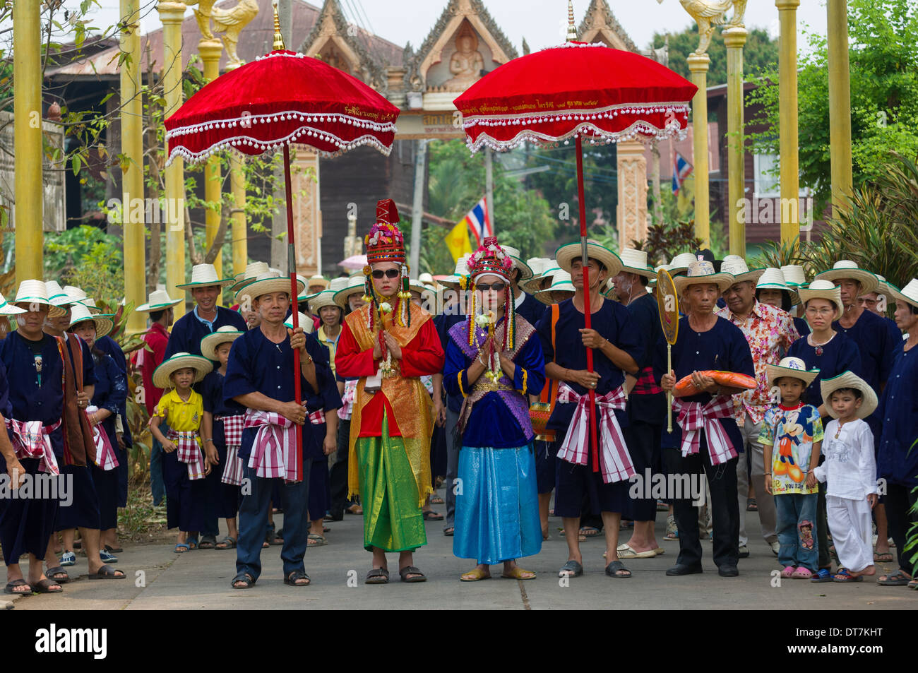 Initiates dressed in garish costumes and sunglasses being processed by ...