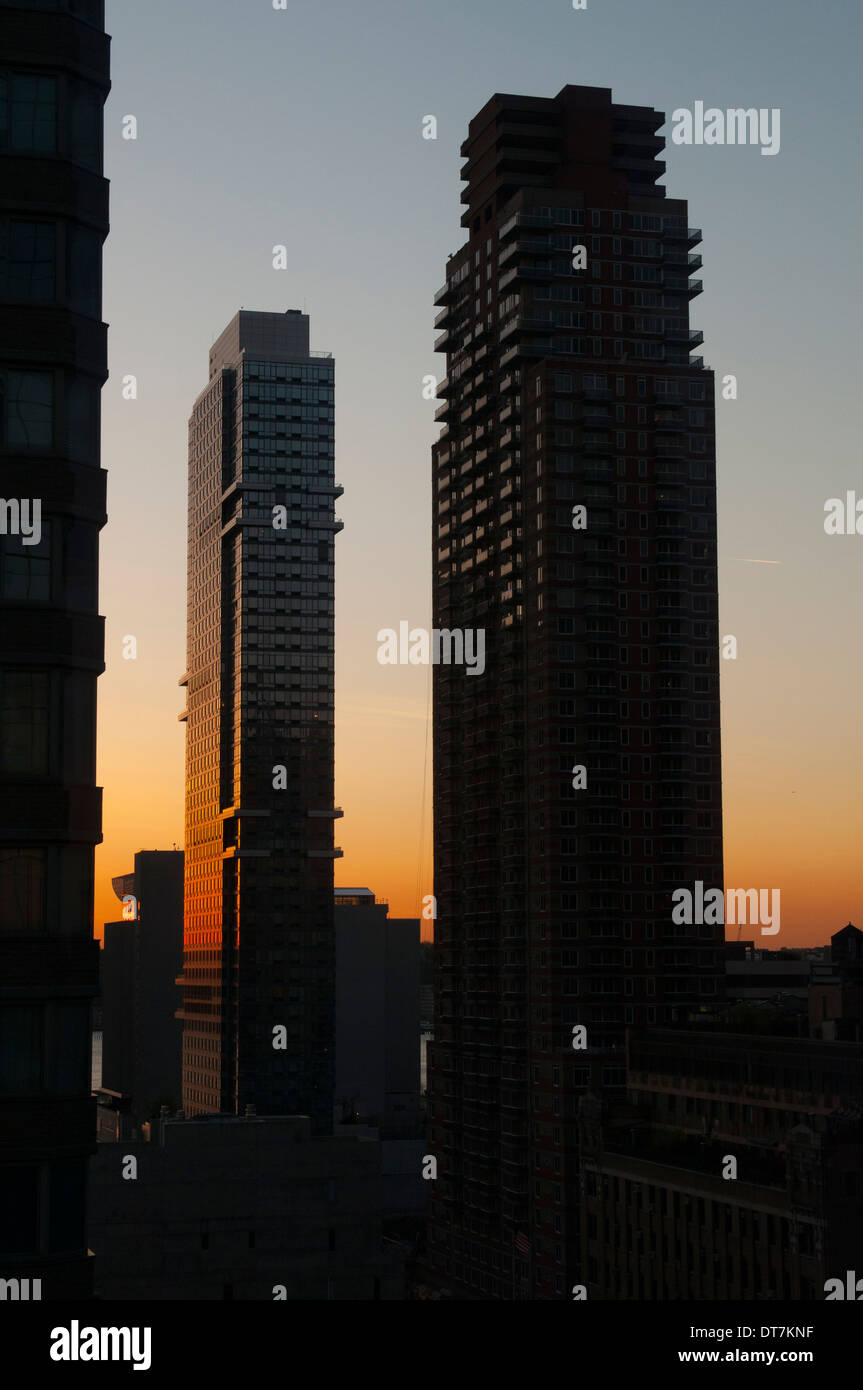 Skyscrapers silhouetted at sunset in Midtown Manhattan New York City ...
