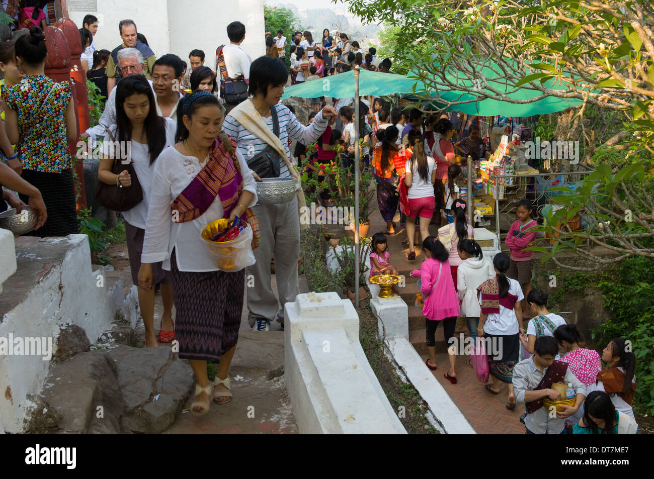 Pilgrims making their way up to Wat Tham Phousi with offerings, Mount ...