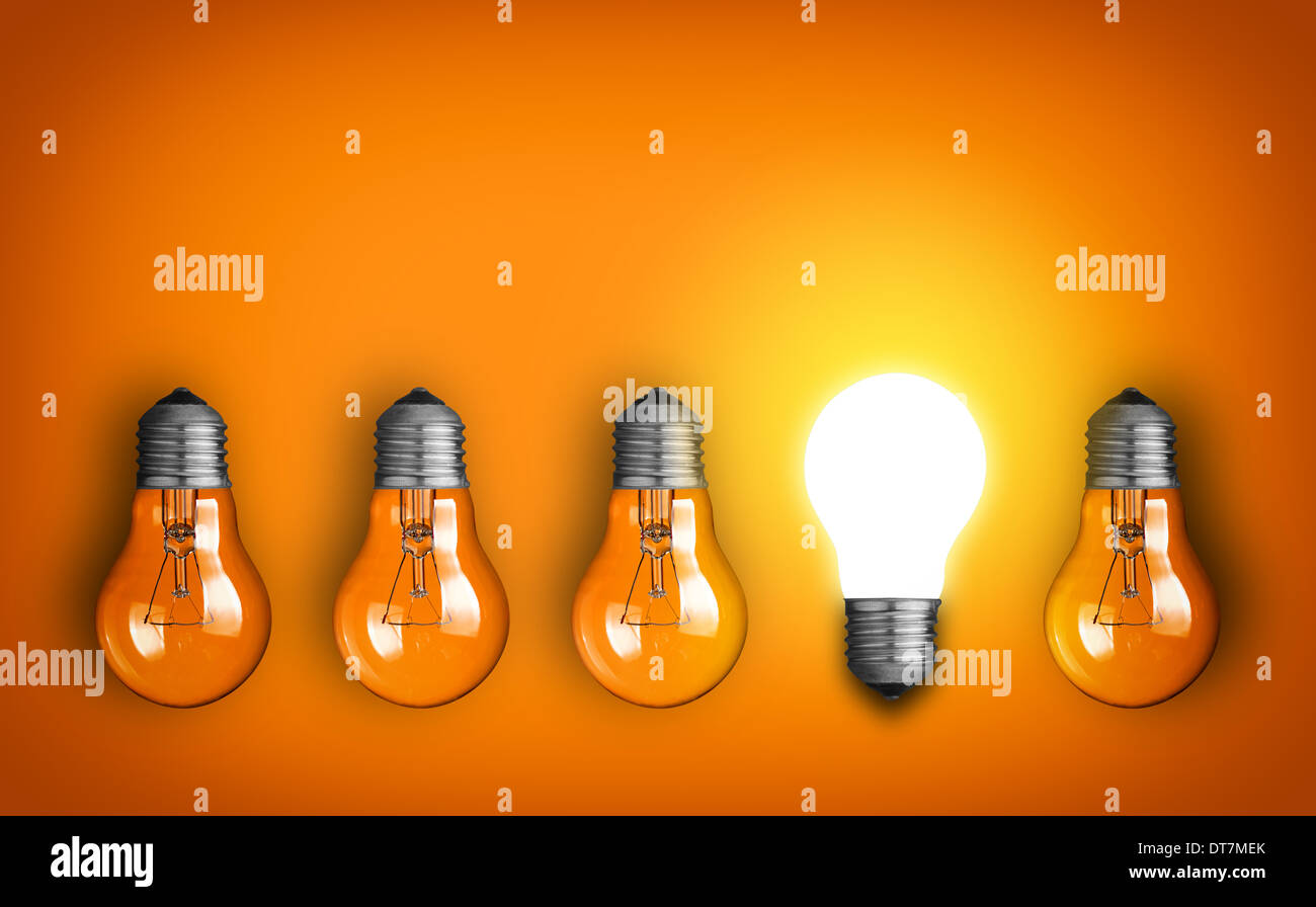 Idea concept with row of light bulbs and glowing bulb Stock Photo - Alamy