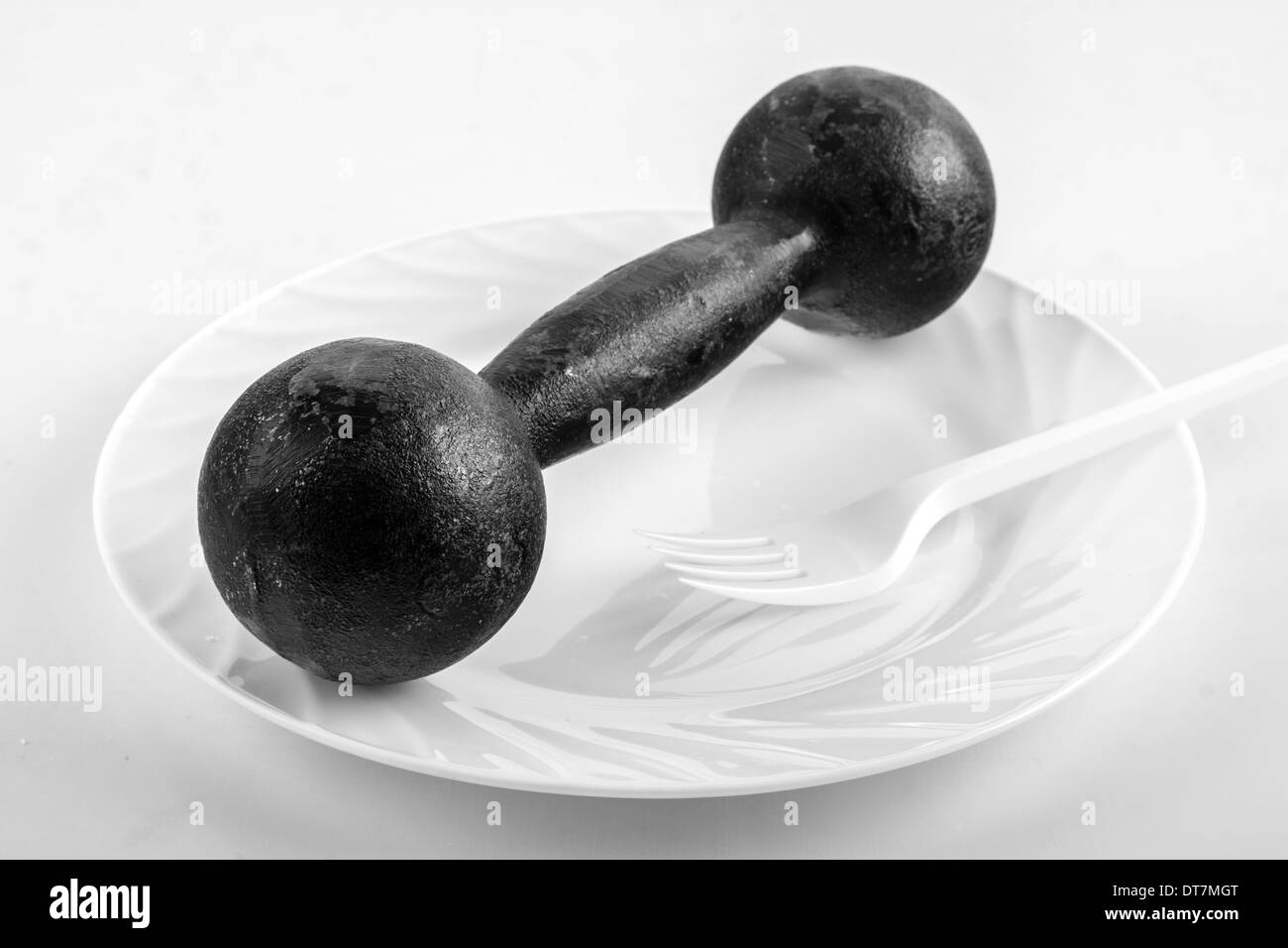 Dumbbell photo on a plate Stock Photo - Alamy