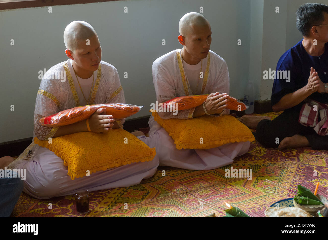 Initiates praying at a family party before being processed to Wat Hat ...