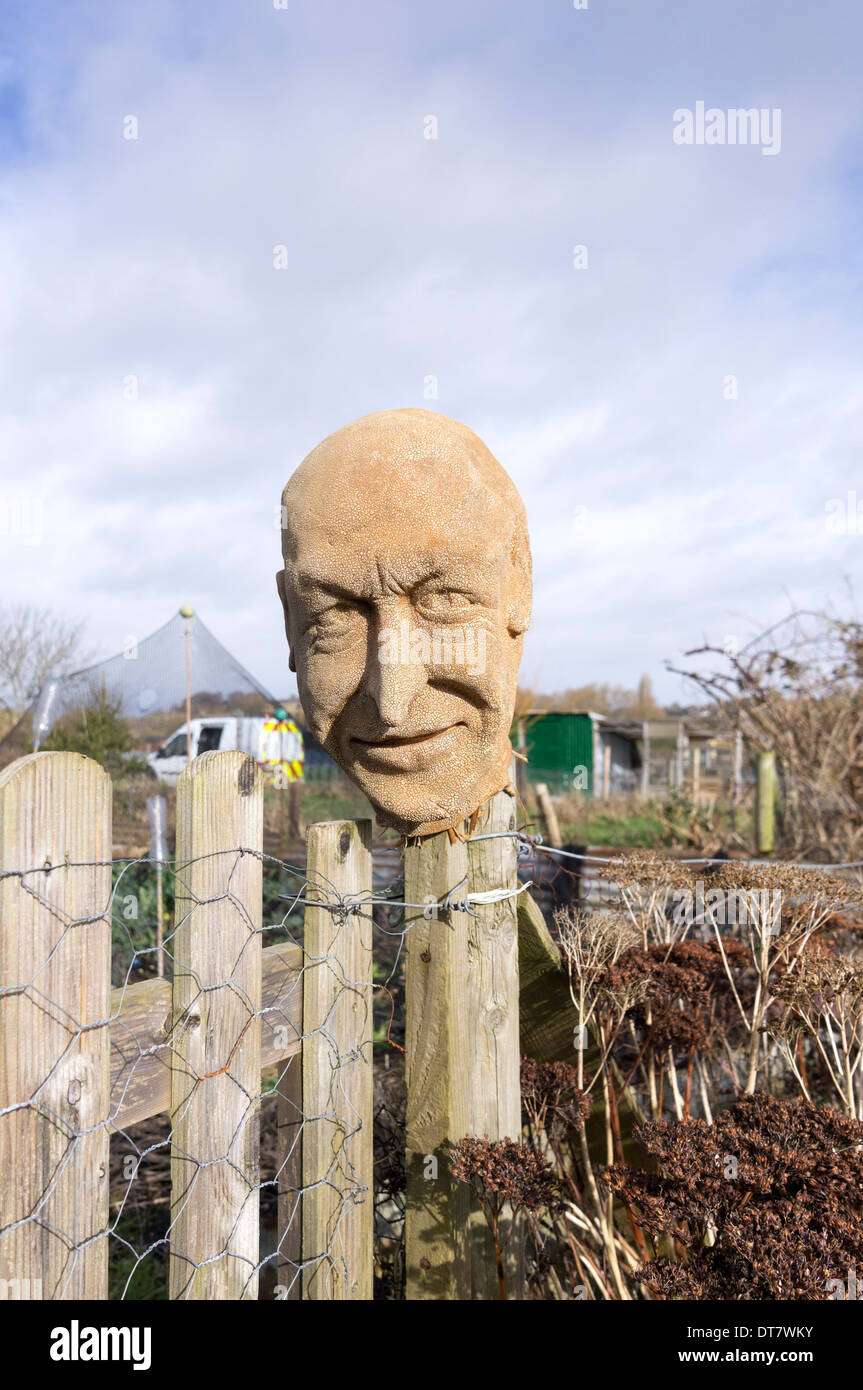 Rubber face mask on wooden fence post Stock Photo - Alamy
