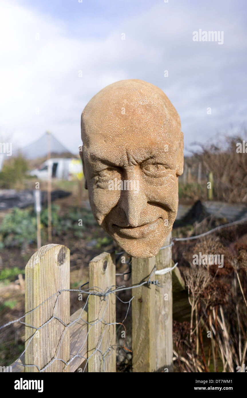 Rubber face mask on wooden fence post Stock Photo - Alamy