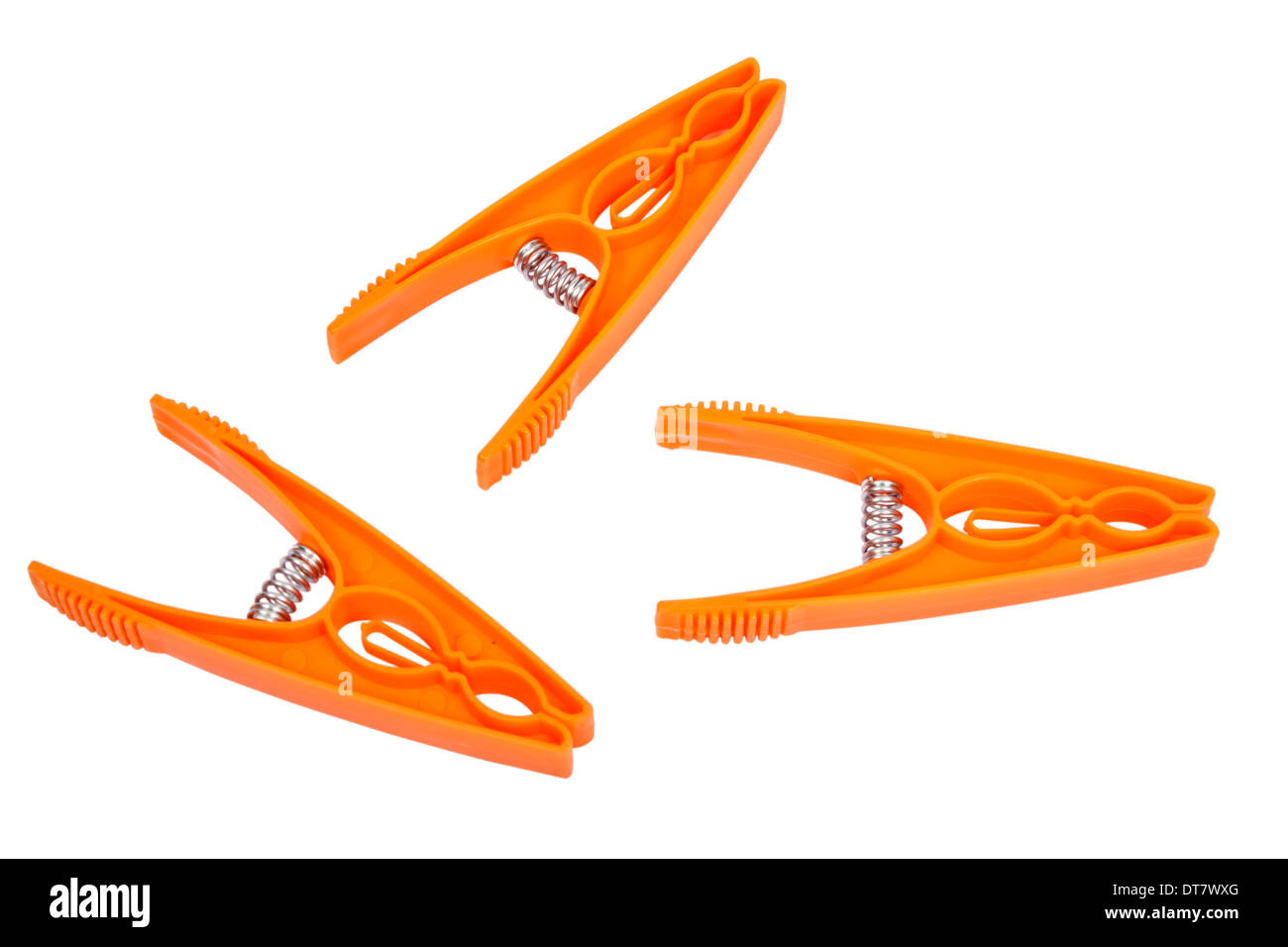 Three orange pegs isolated on white background Stock Photo - Alamy