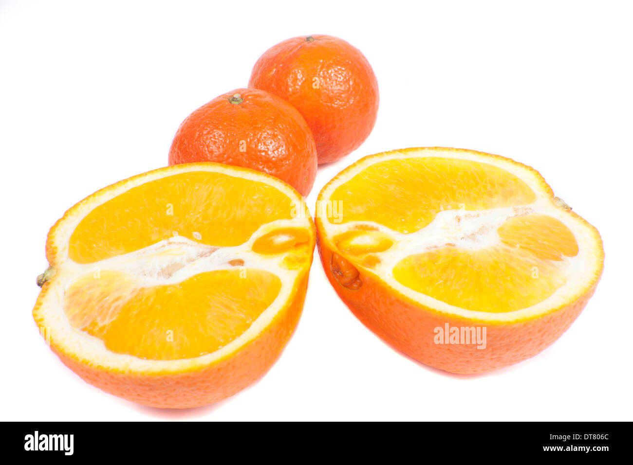 One sliced orange and two tangerines isolated over white background ...