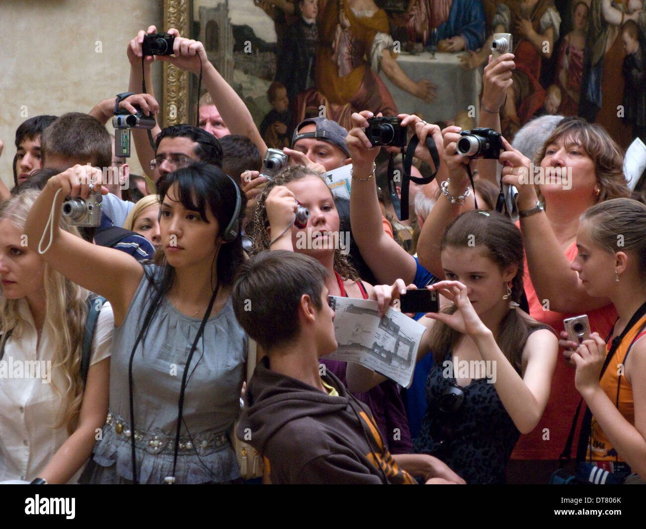 Louvre. Visitors to the museum photographing the painting the Mona Lisa ...