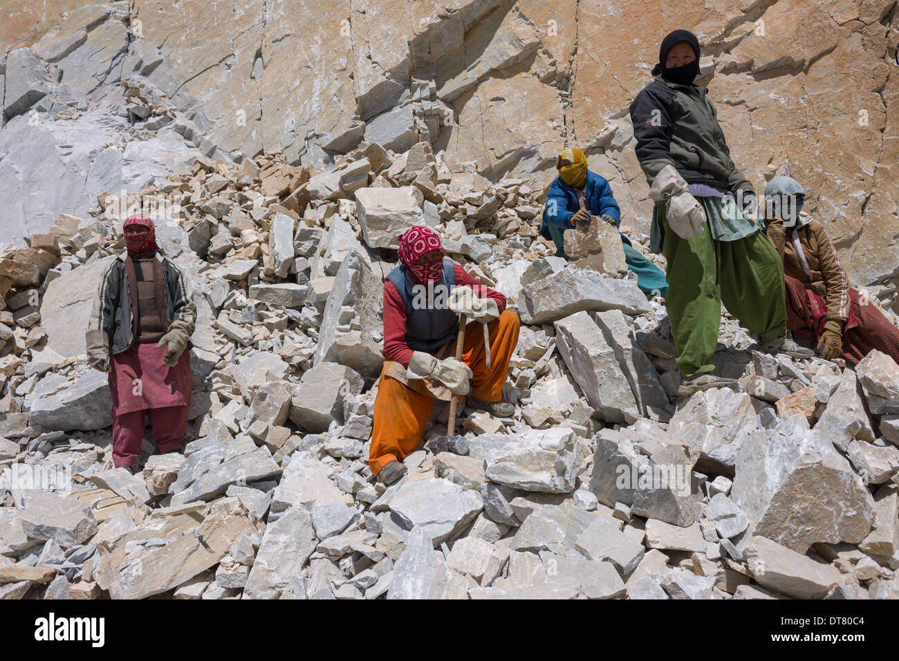 Women labourers taking a break from breaking rocks by hand, on the Leh ...