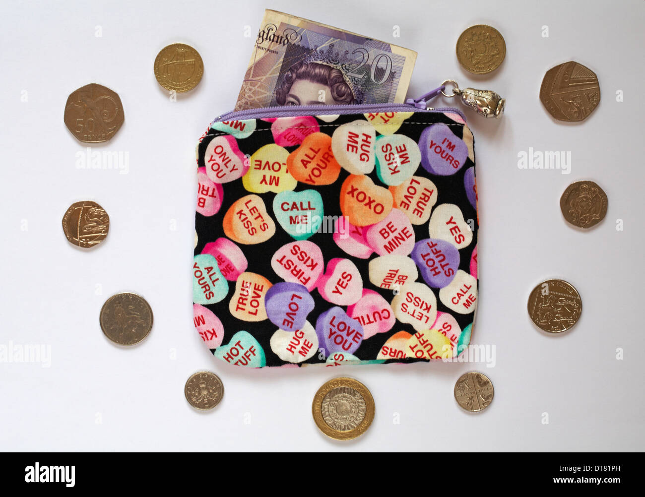 Love hearts purse with £20 note and British coins in the shape of a ...