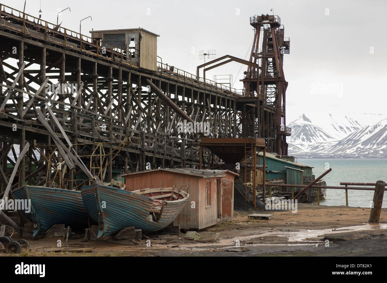 Derelict wooden loading jetty and woodn boats at the harbour of the ...