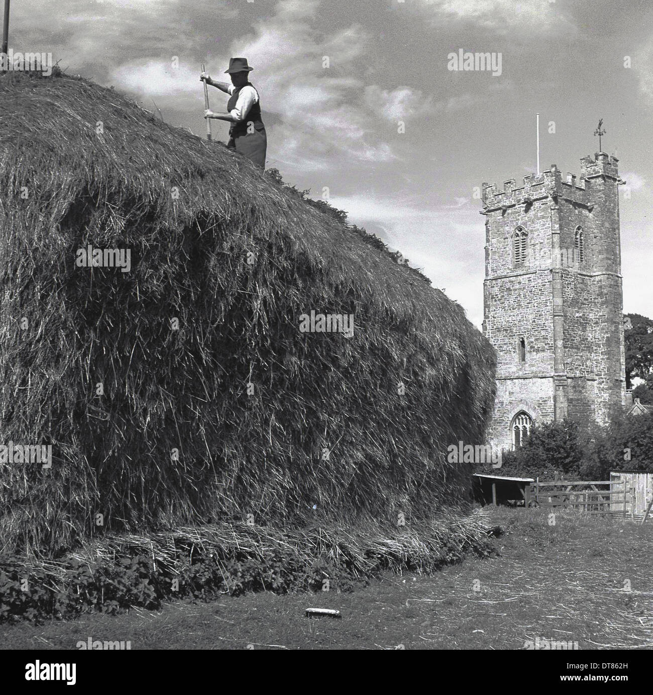 Historical picture from 1950s showing a farmer with a pitchfork on top ...