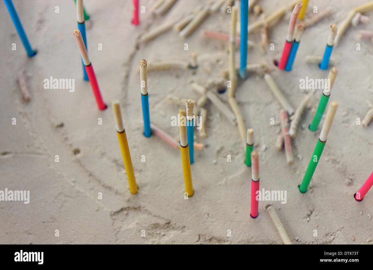Colored sticks in sand Stock Photo - Alamy