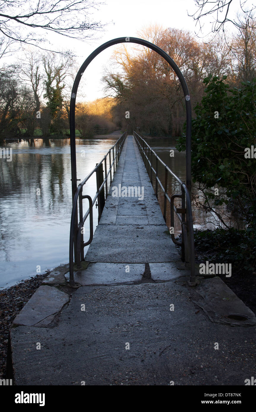 The ford at Moreton in winter. A long pedestrian bridge spans this ...