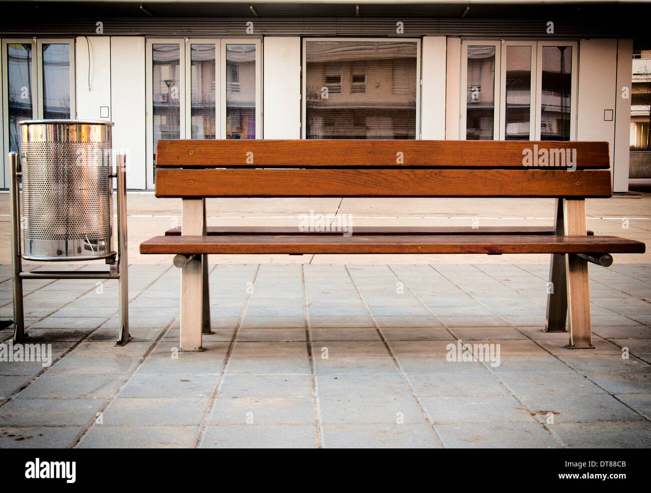 Empty wooden bench in the city block Stock Photo - Alamy
