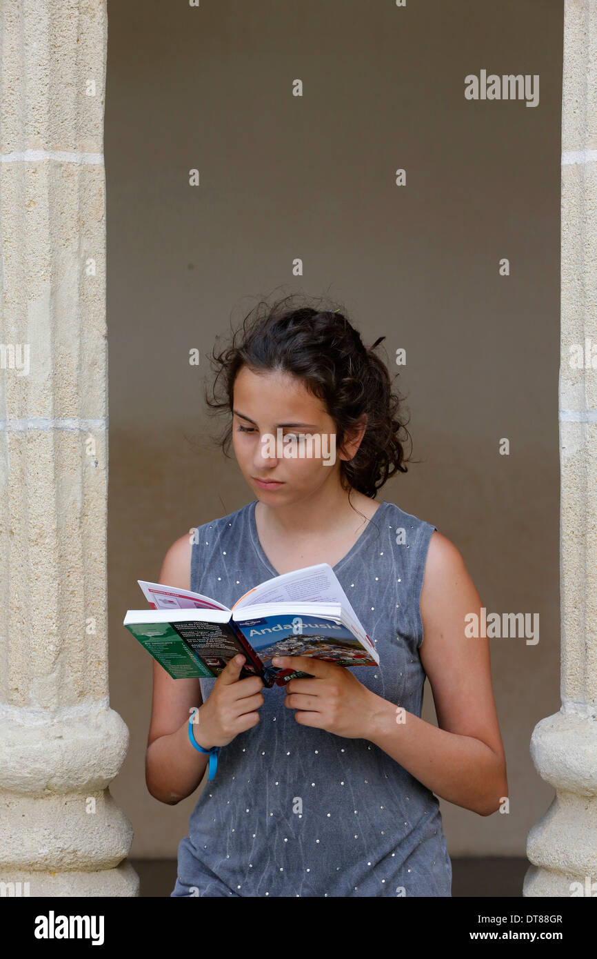 Teenager reading a guidebook Stock Photo - Alamy